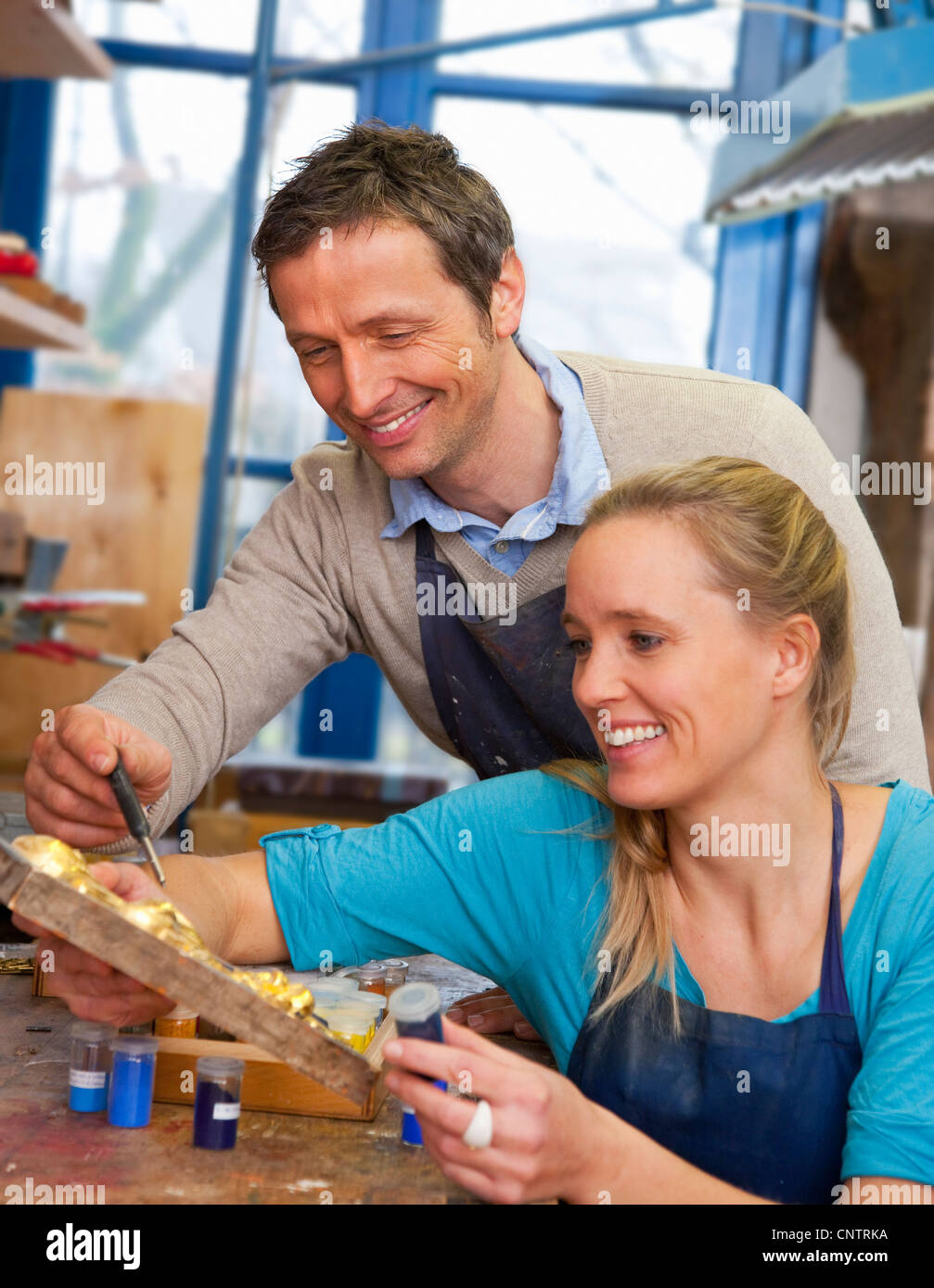 Carpenter working with assistant in shop Stock Photo - Alamy