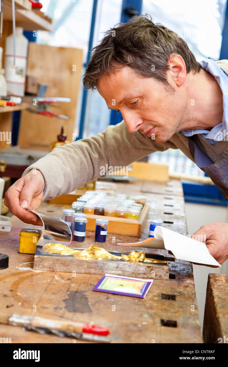 Carpenter matching pigment to paint Stock Photo - Alamy