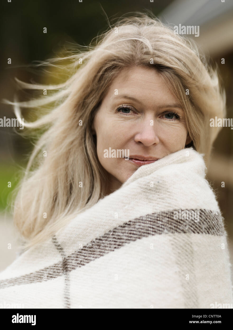 Woman wrapped in blanket outdoors Stock Photo - Alamy
