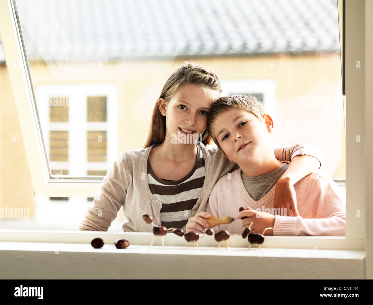 Children standing together in window Stock Photo - Alamy