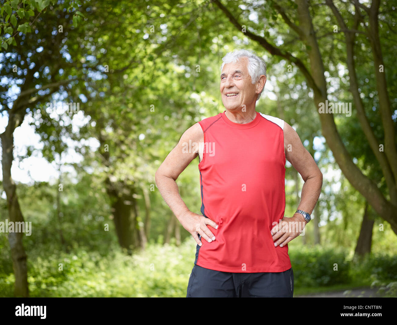 Smiling older man standing outside Stock Photo - Alamy