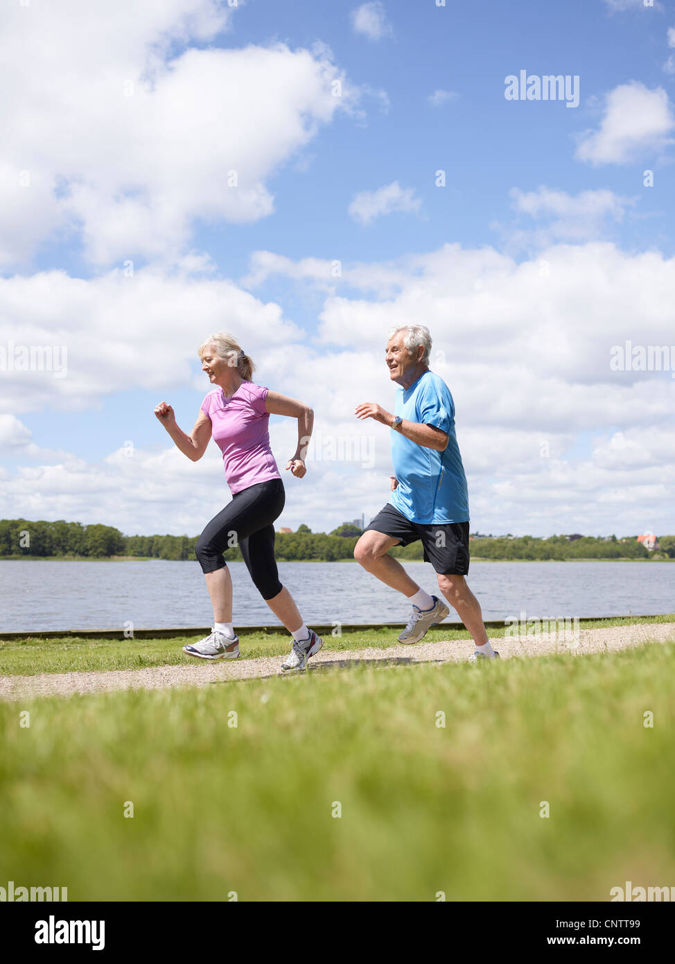 Older couple running together outdoors Stock Photo - Alamy