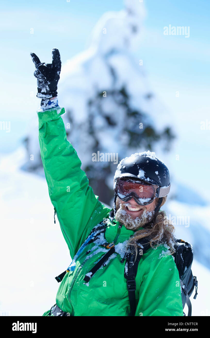Skier making hand gesture in snow Stock Photo - Alamy