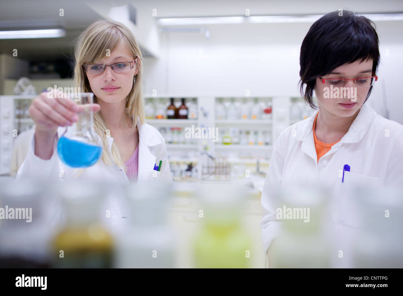 two female researchers carrying out research in a chemistry lab (color ...
