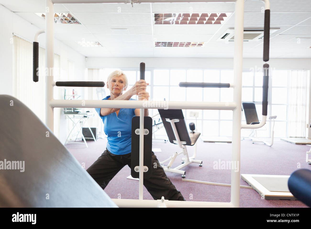 Older woman exercising in gym Stock Photo - Alamy