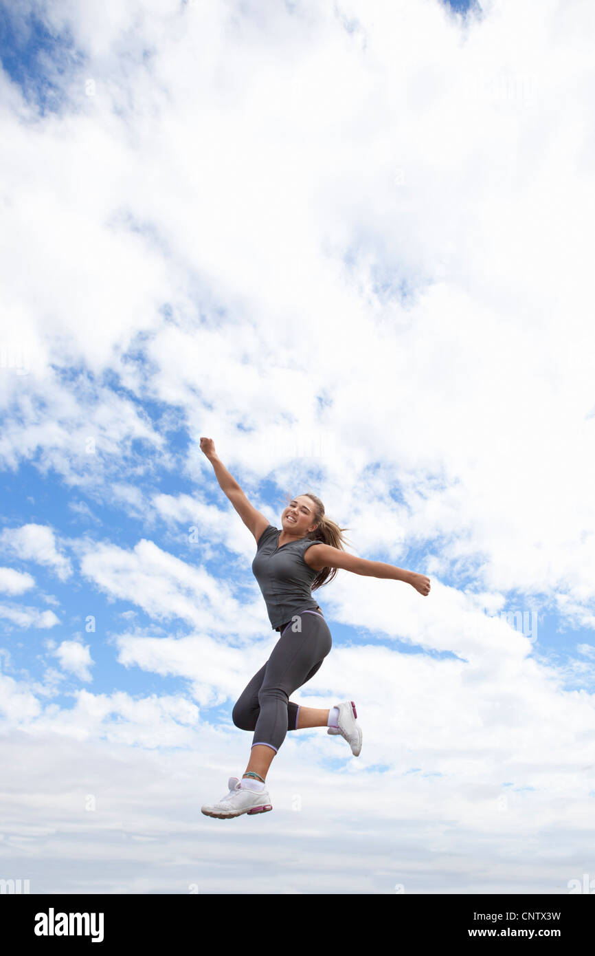 Runner jumping for joy outdoors Stock Photo - Alamy
