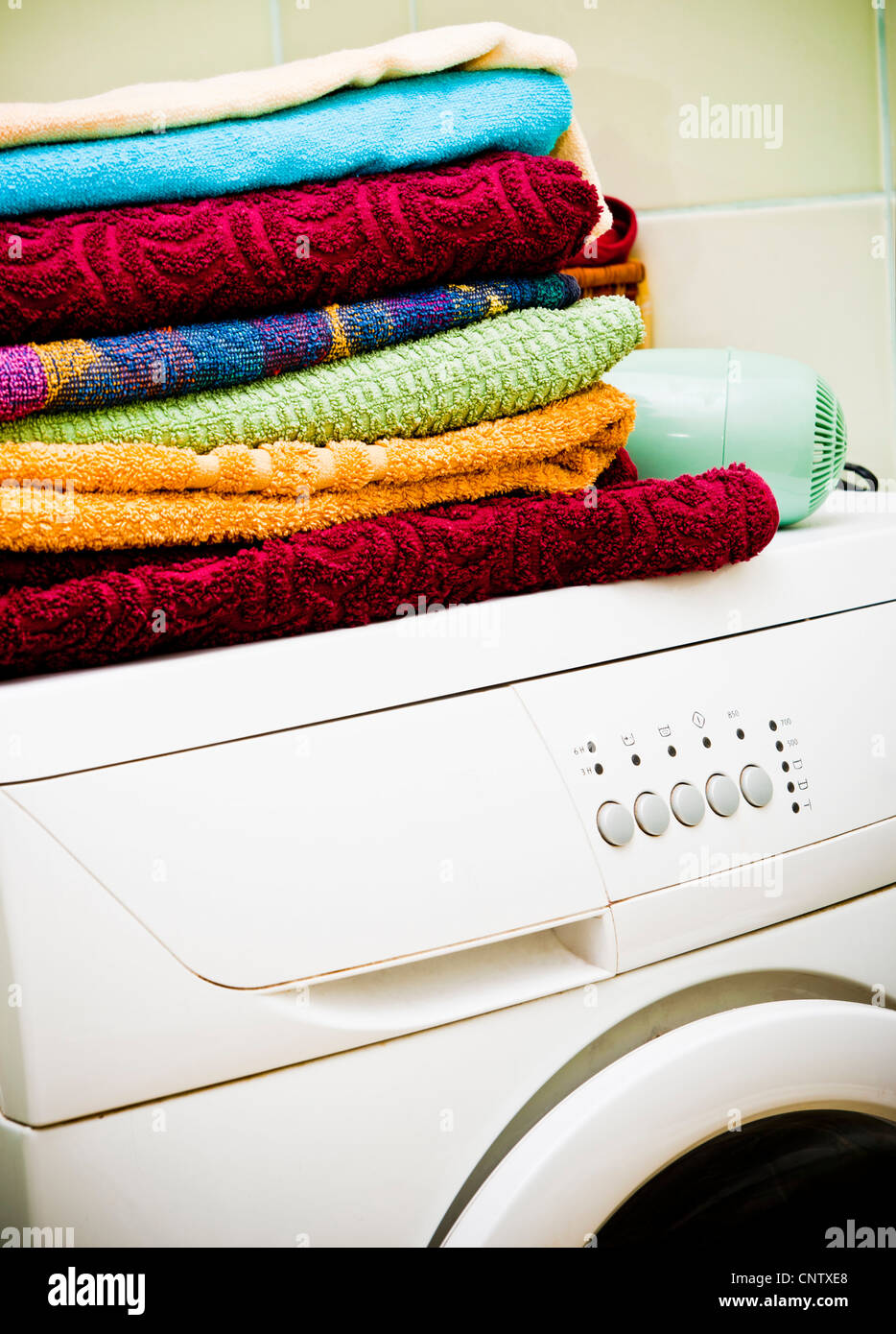 Woshingmachine with tile in bathroom Stock Photo - Alamy