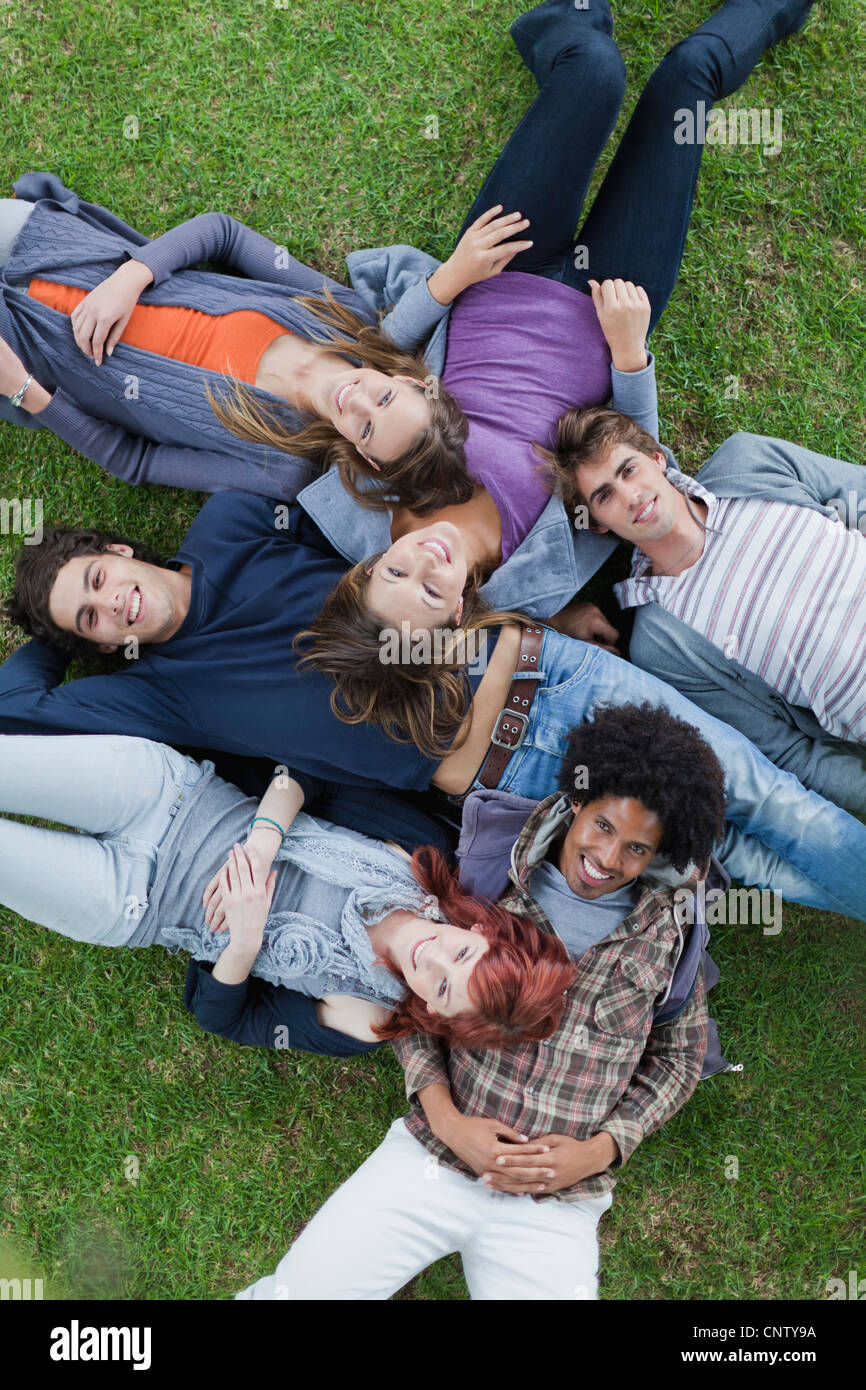 Students laying in grass on campus Stock Photo - Alamy