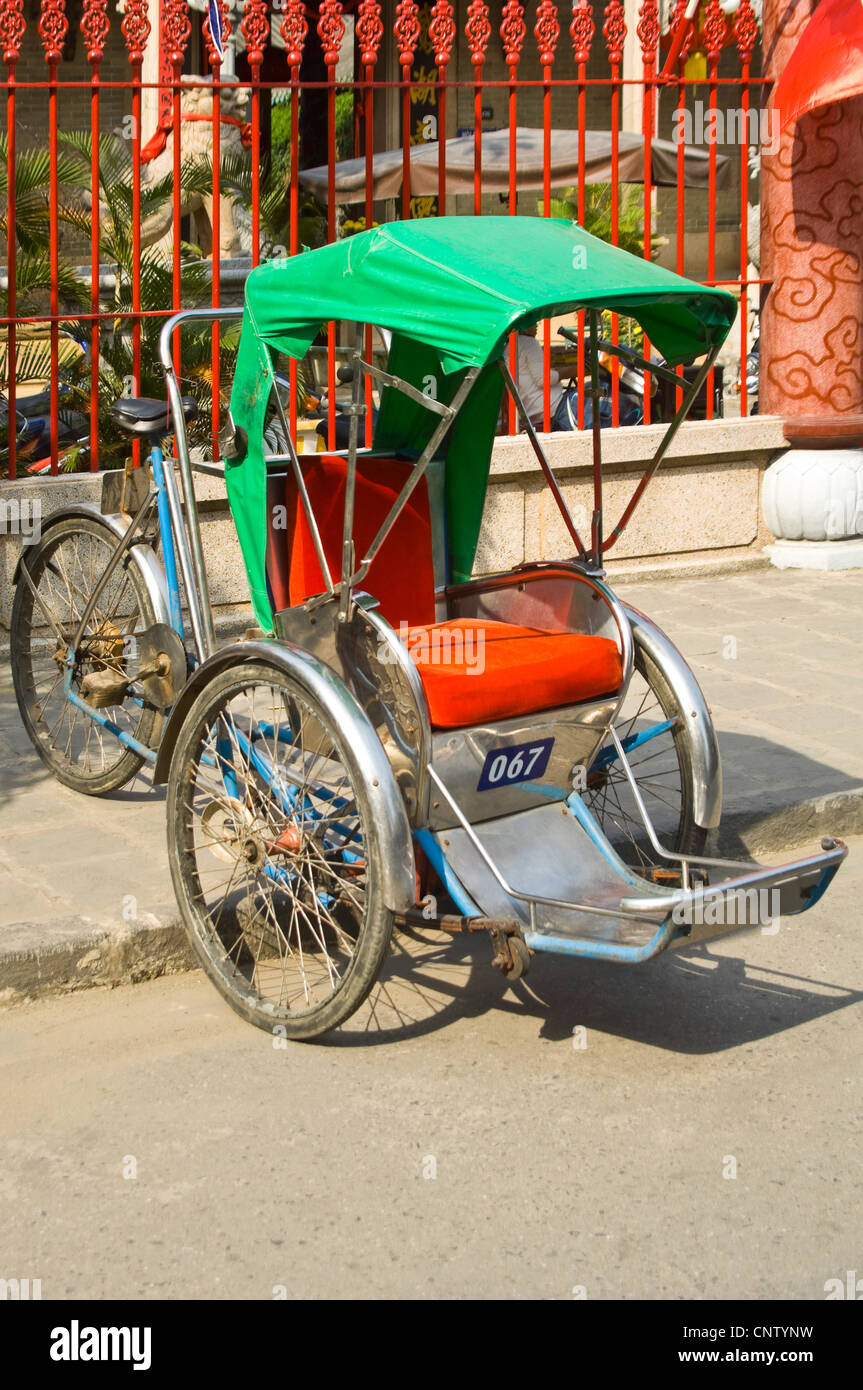 Vertical view of an empty cycle-rickshaw or cyclo parked on the ...