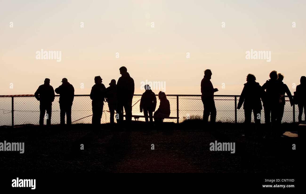 Silhouettes of people at the fence over a cliff Stock Photo - Alamy
