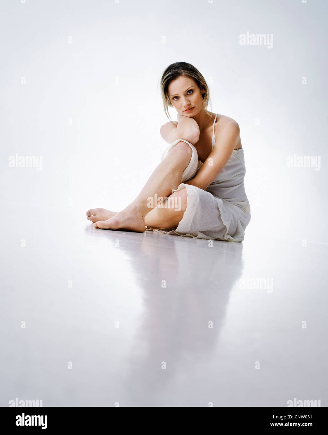 Woman sitting on floor Stock Photo - Alamy