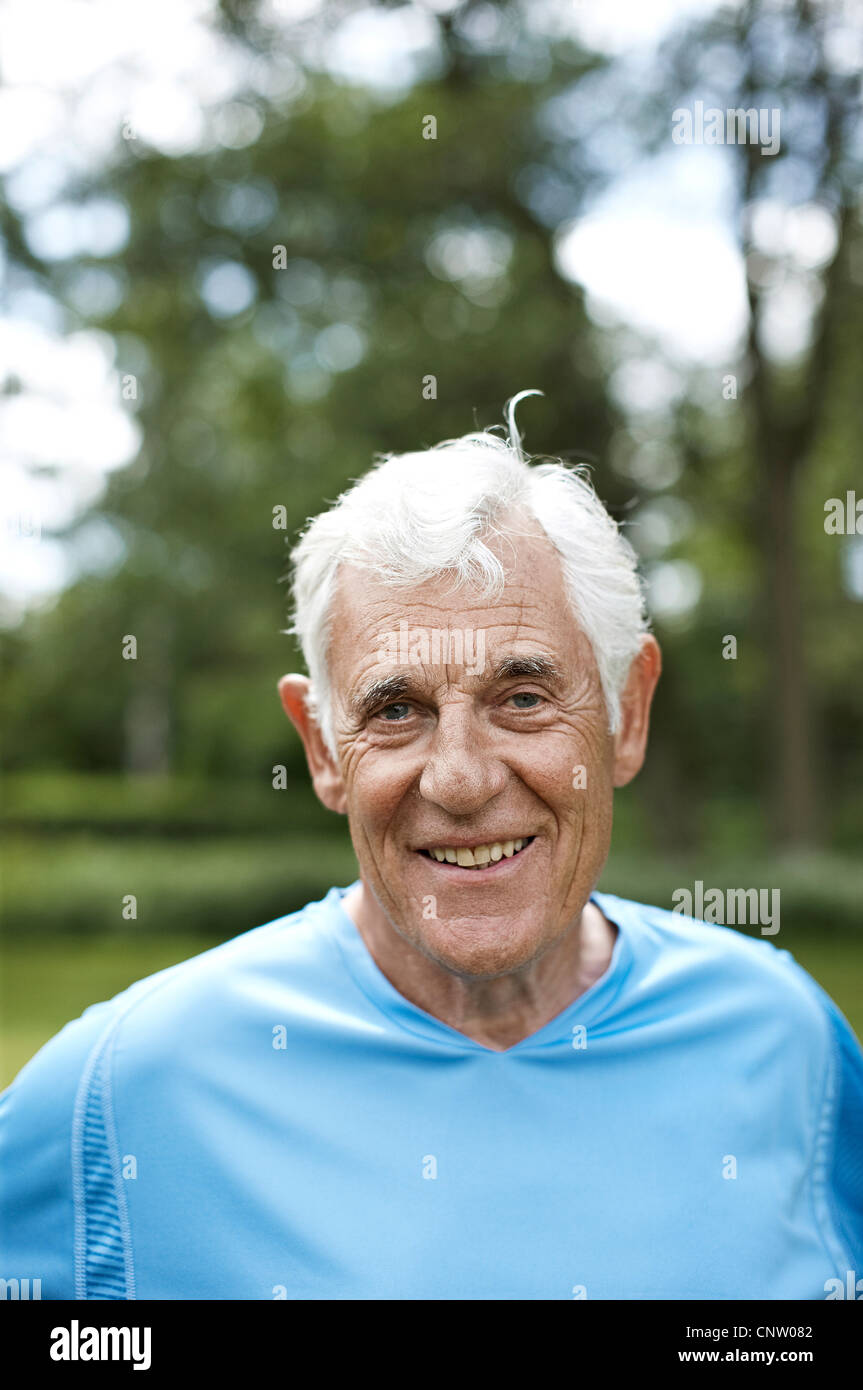 Smiling older man standing outside Stock Photo - Alamy