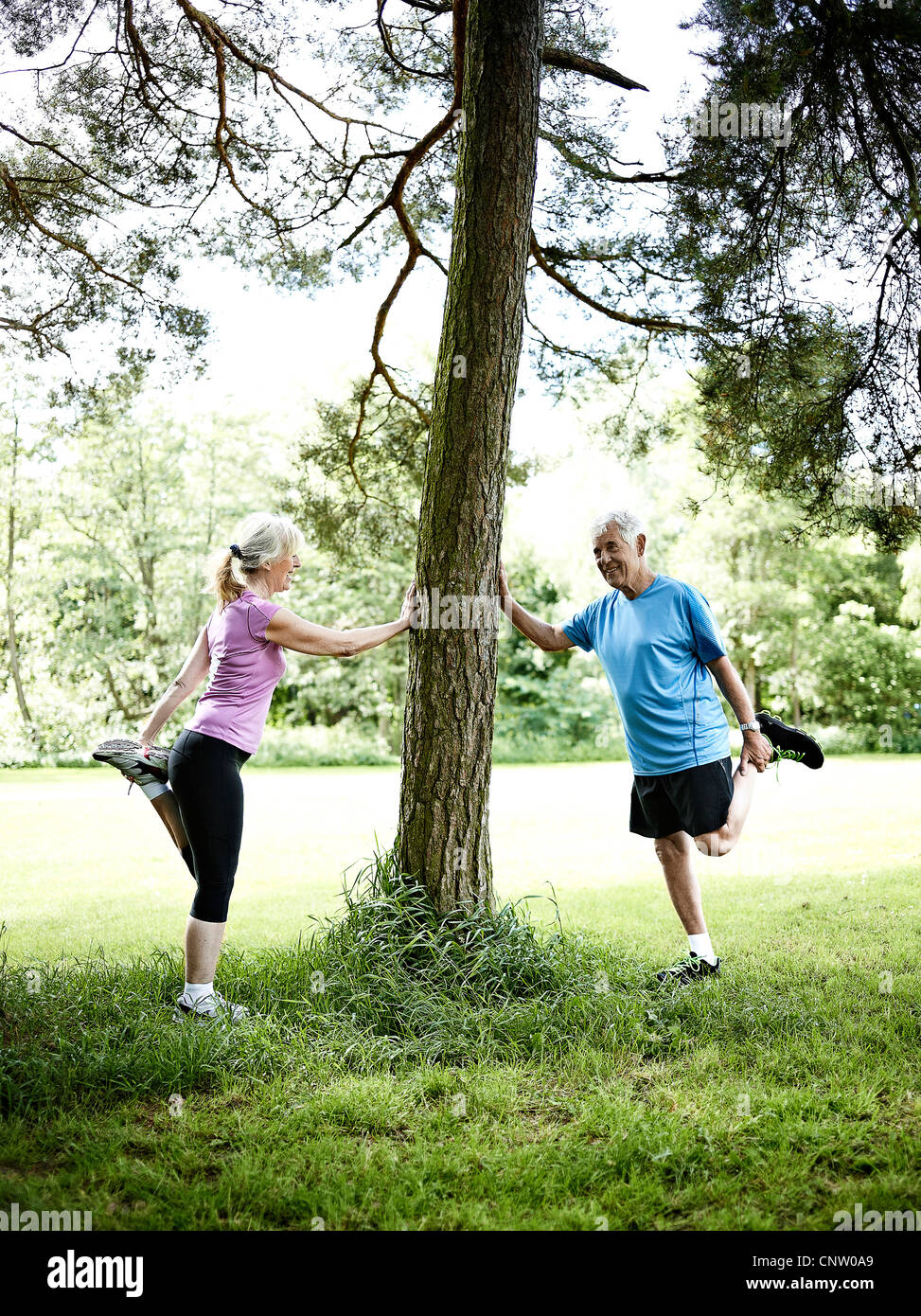 Senior woman leaning against tree hi-res stock photography and images ...