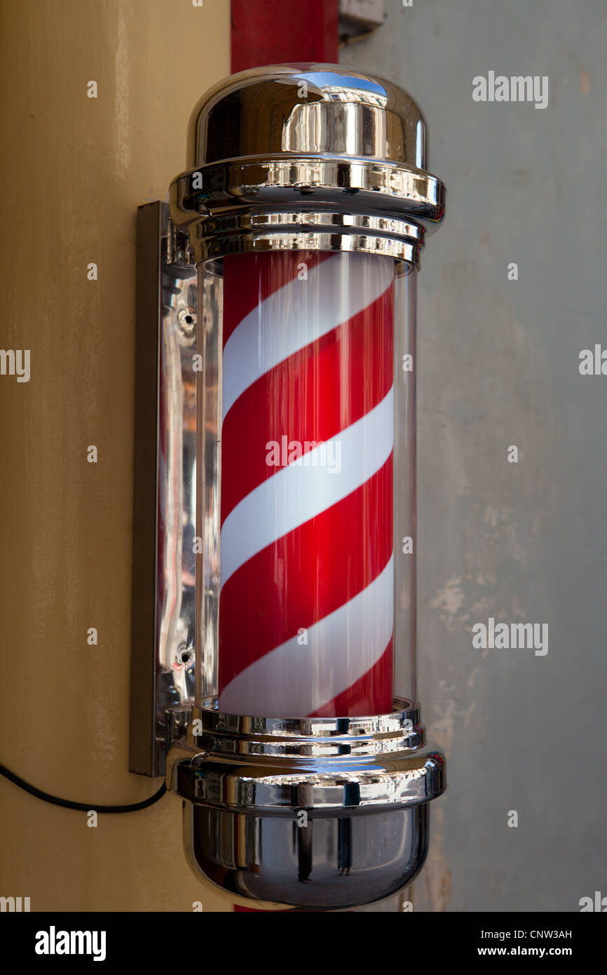 A traditional barber shop sign, illuminated and rotating Stock Photo ...