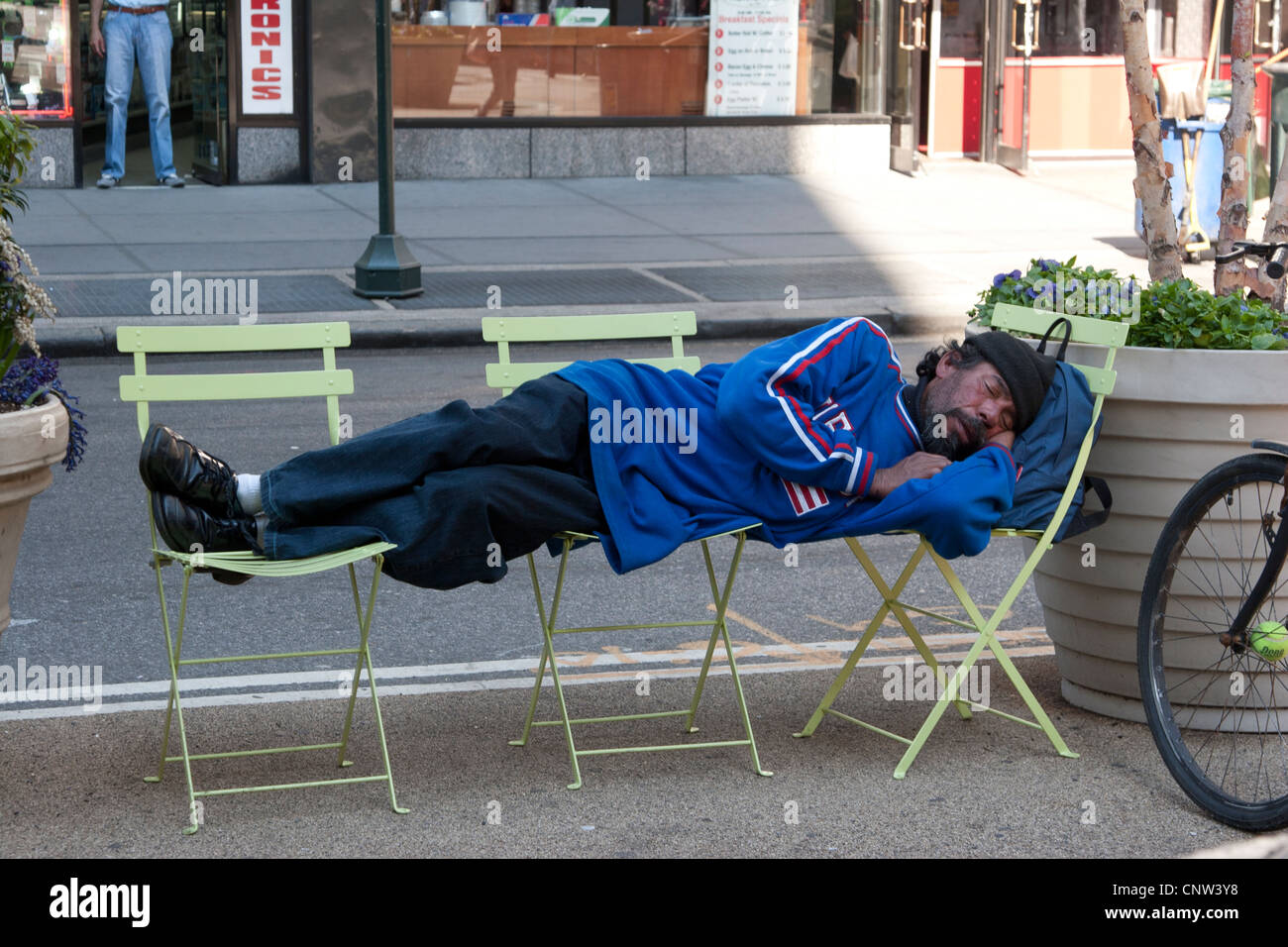 Homeless man makes himself comfortable on the pedestrian mall along ...