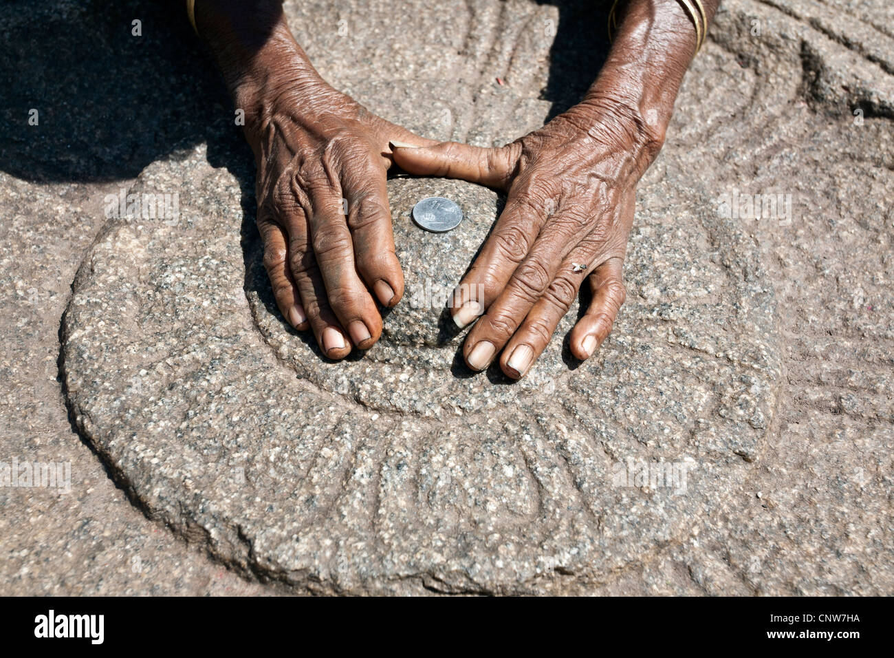 Indian woman worshiping a sacred stone (hindu ritual). Virupaksha ...