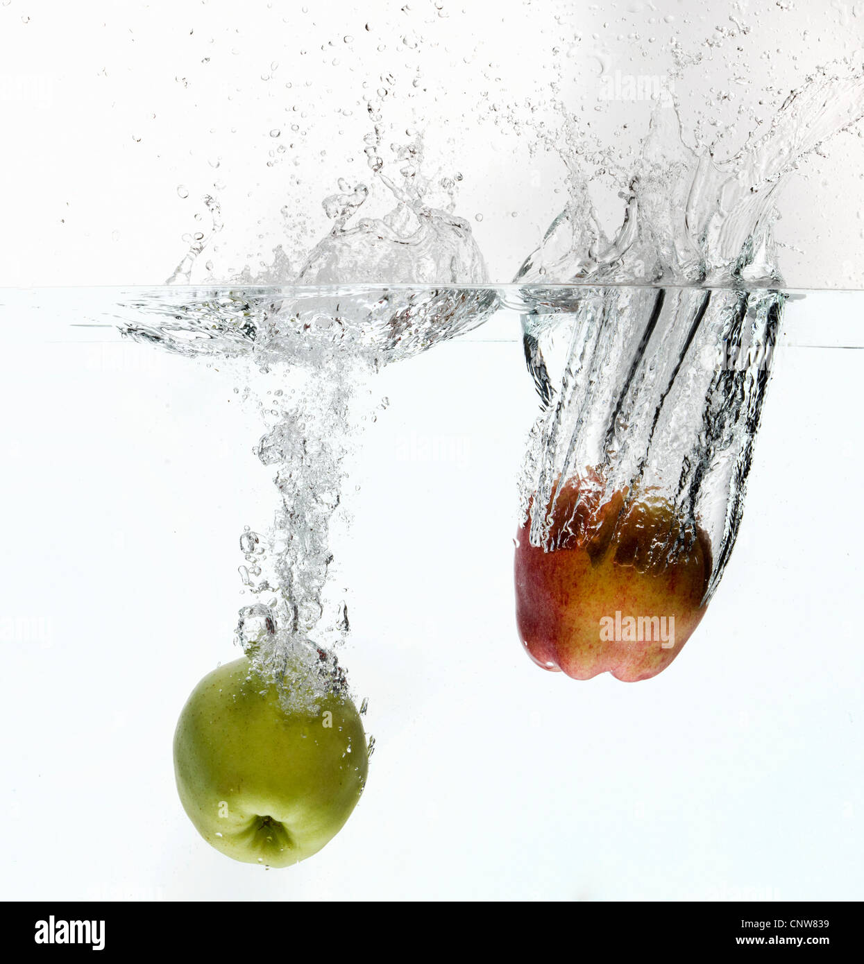 Apples splashing in water Stock Photo - Alamy