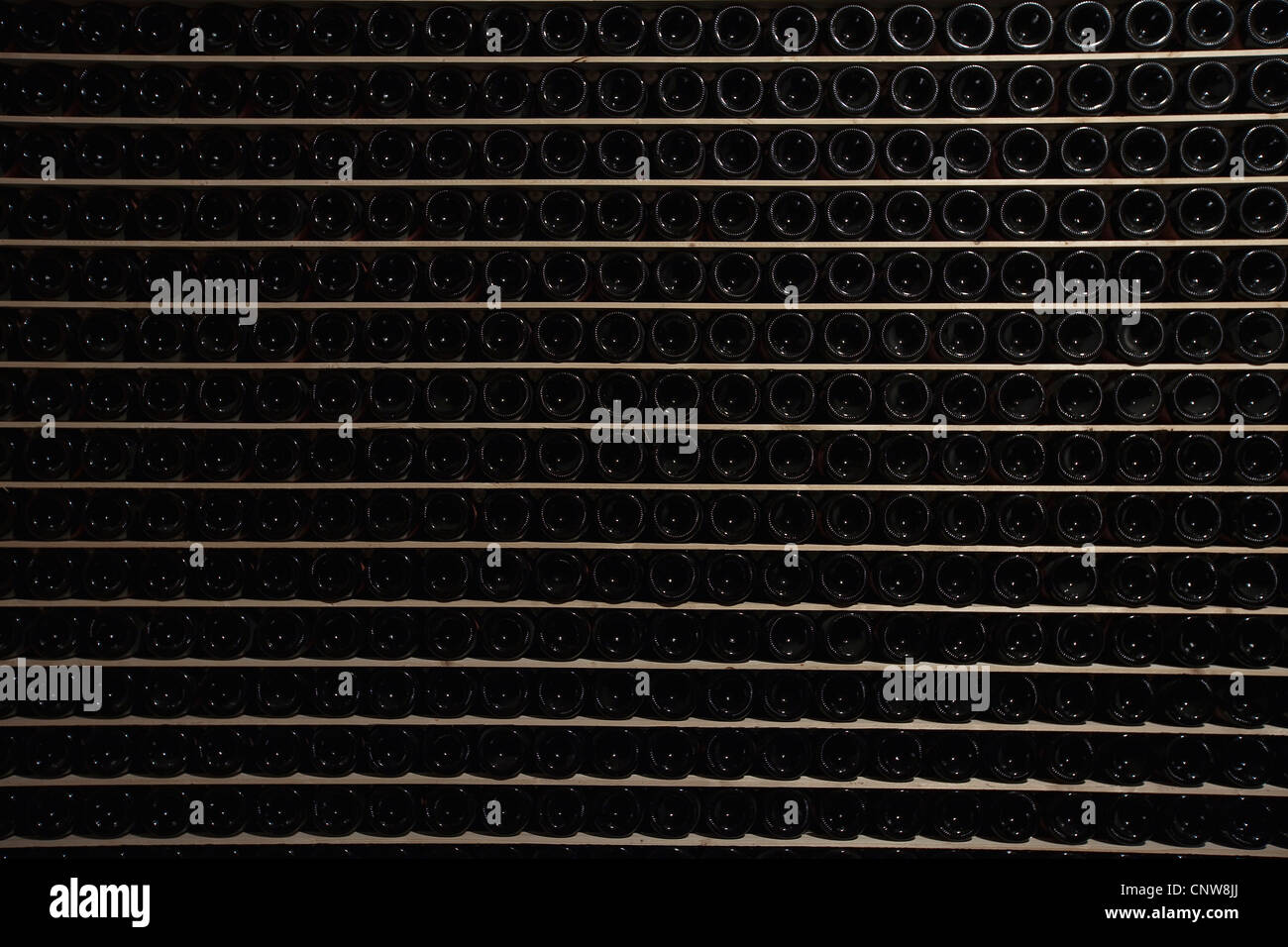 Empty bottles of wine in rack Stock Photo - Alamy