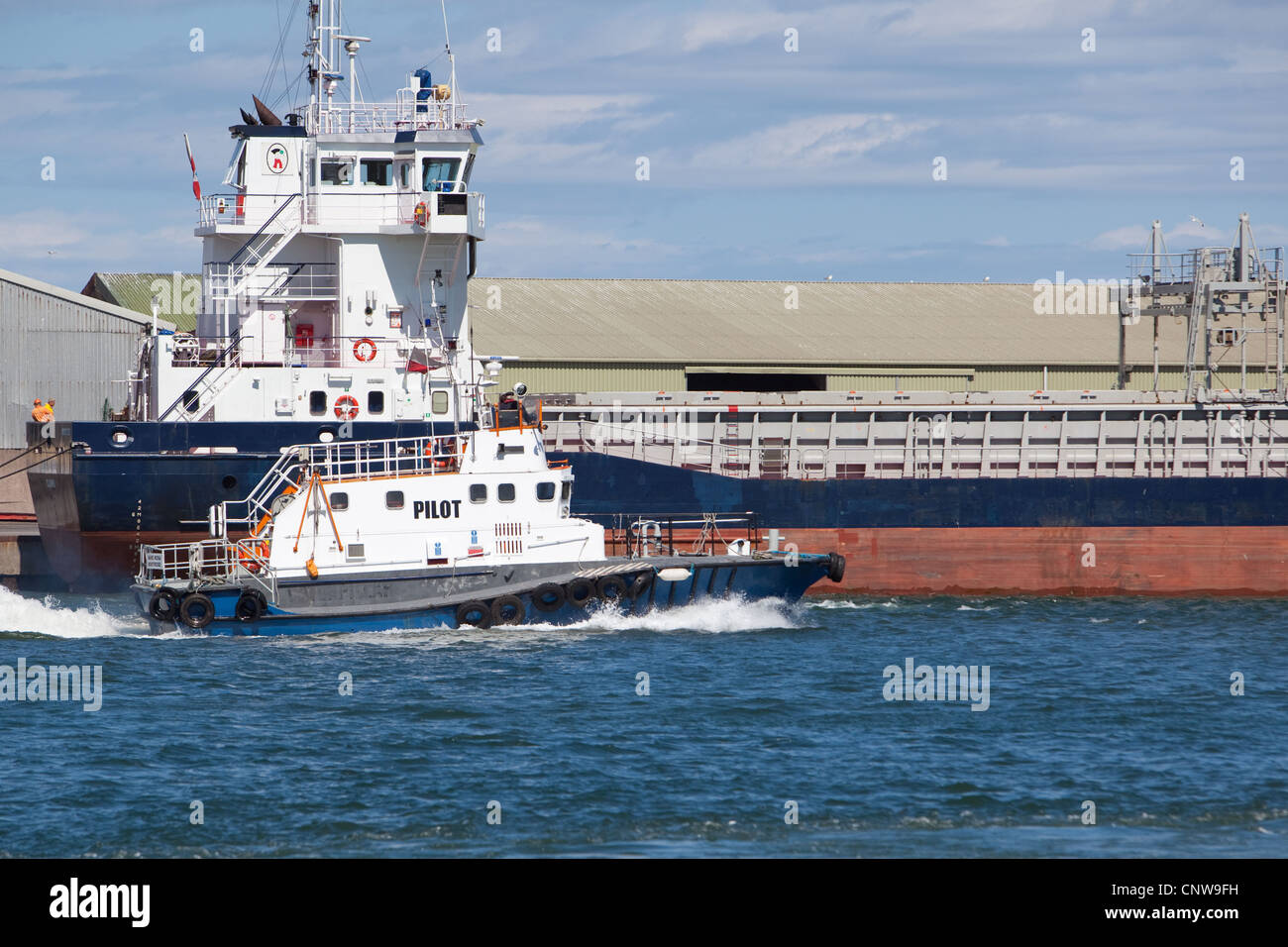 Pilot vessel & cargo ship leaving Montrose Harbour Scotland UK Stock ...