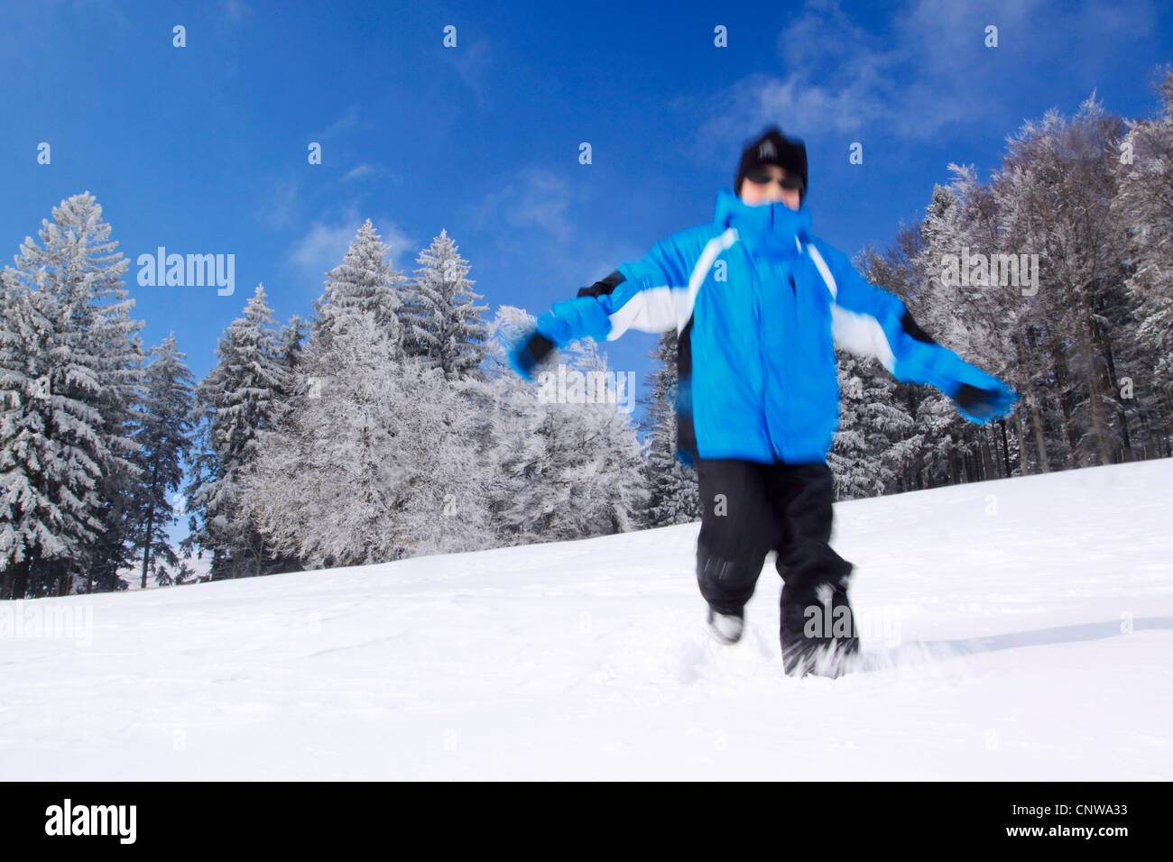 boy frolicly playing in the snow, Switzerland Stock Photo - Alamy