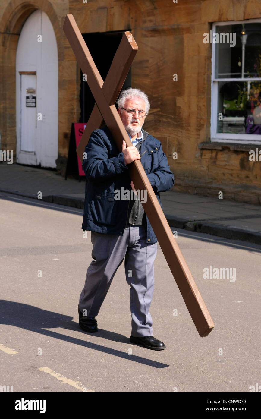 Christian Man carrying the Cross to mark the crucifixion of Jesus at ...