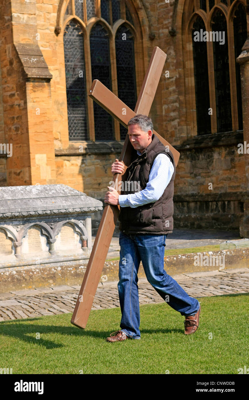 Christian Man carrying the Cross to mark the crucifixion of Jesus at ...