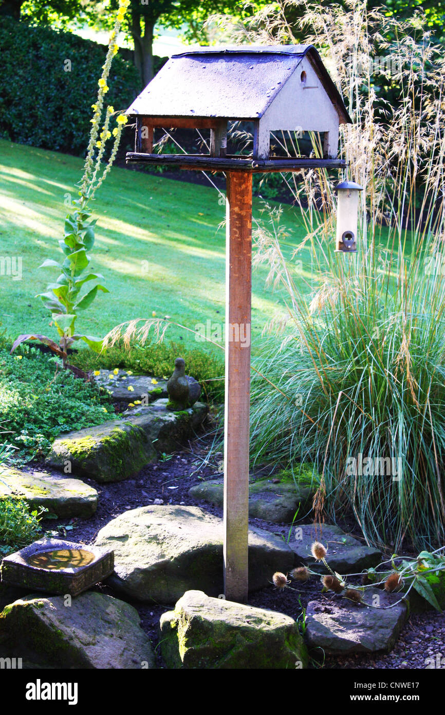 Wooden bird house in a garden Stock Photo - Alamy
