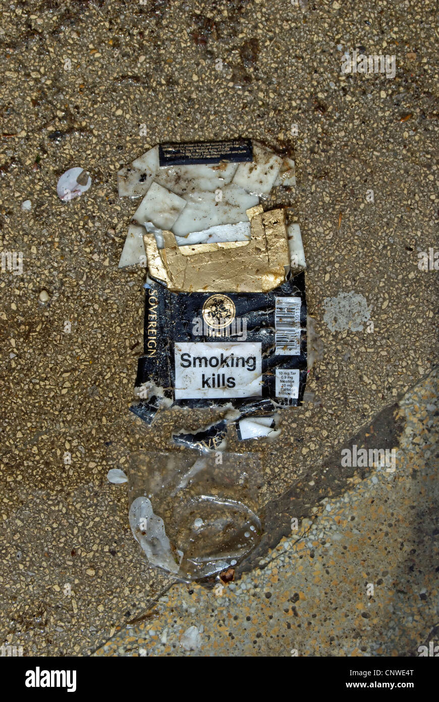 crushed empty packet of benson & hedges sovereign cigarettes on wet ...