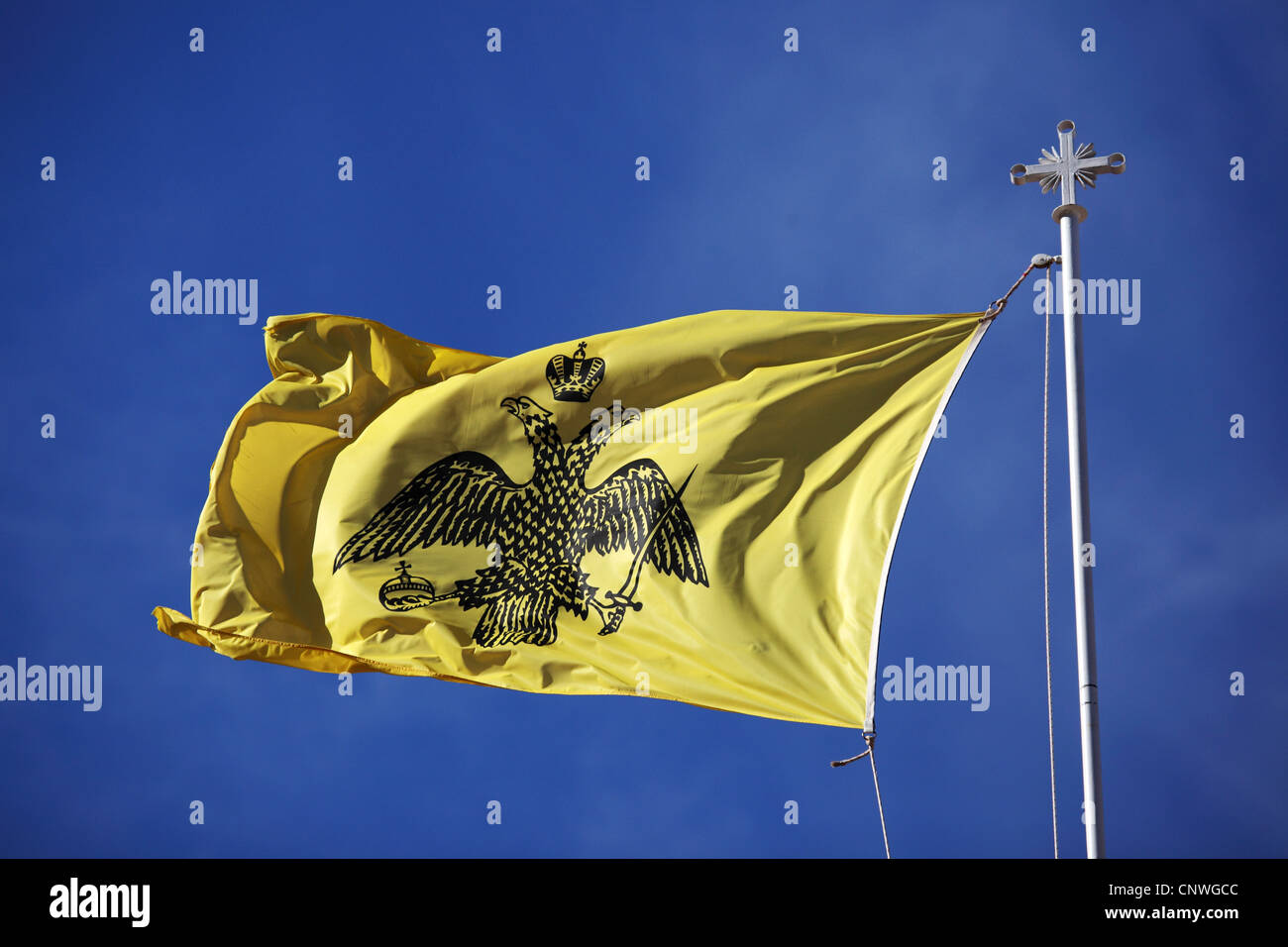 The yellow and black flag of the autonomous state of Mount Athos flies ...