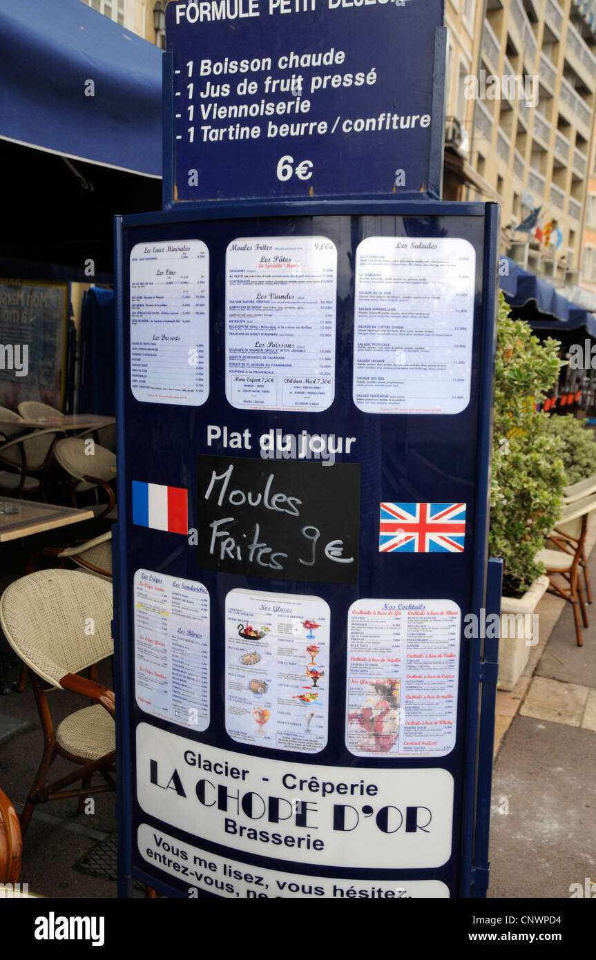 A menu display outside a restaurant, advertising a menu in both French ...