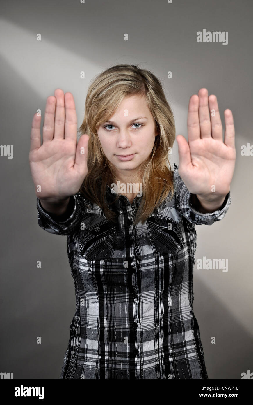 Blonde girl stretched out her hands defensively Stock Photo - Alamy