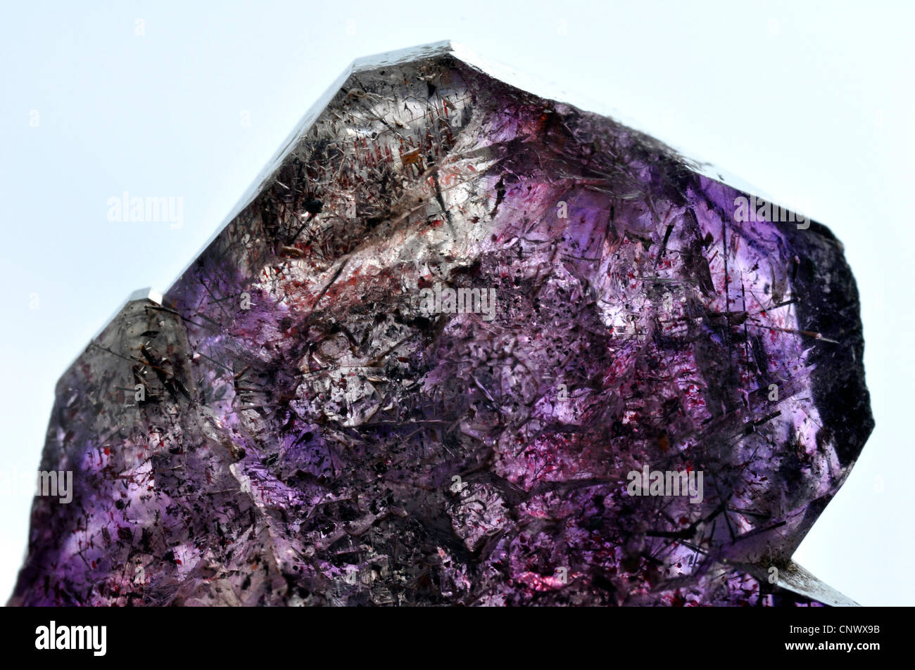 Amethyst with inclusions of rutile and haematite Stock Photo - Alamy