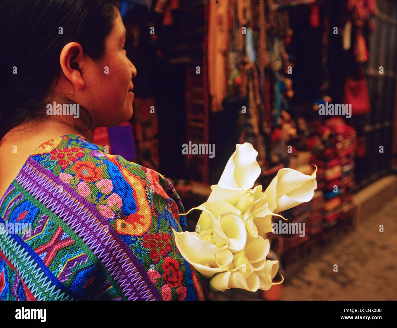 A Mayan weaver poses with cala lilies in Antigua Guatemala's ...