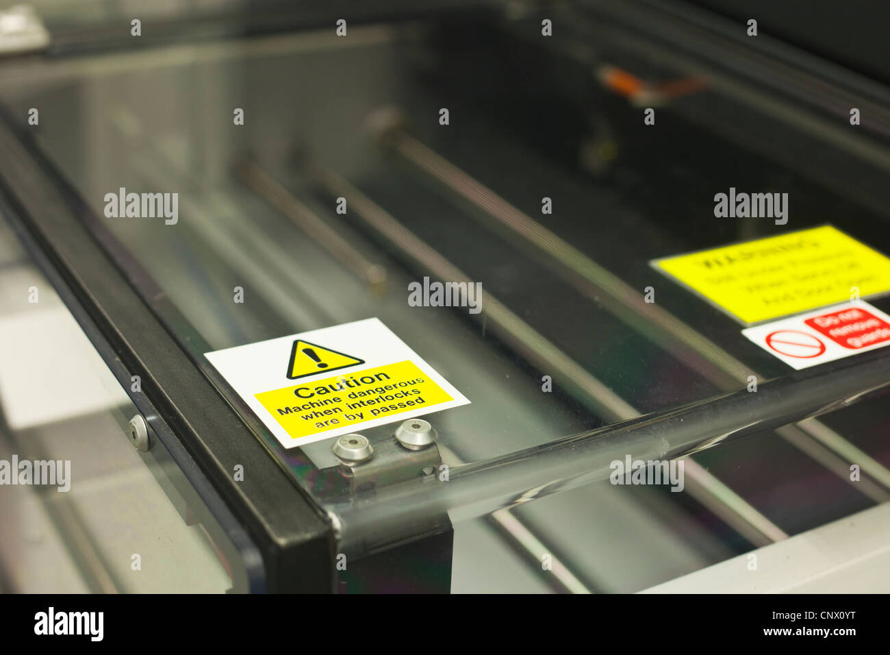 Warning signs fitted to a conveyor on an SMT SMD production line Stock ...