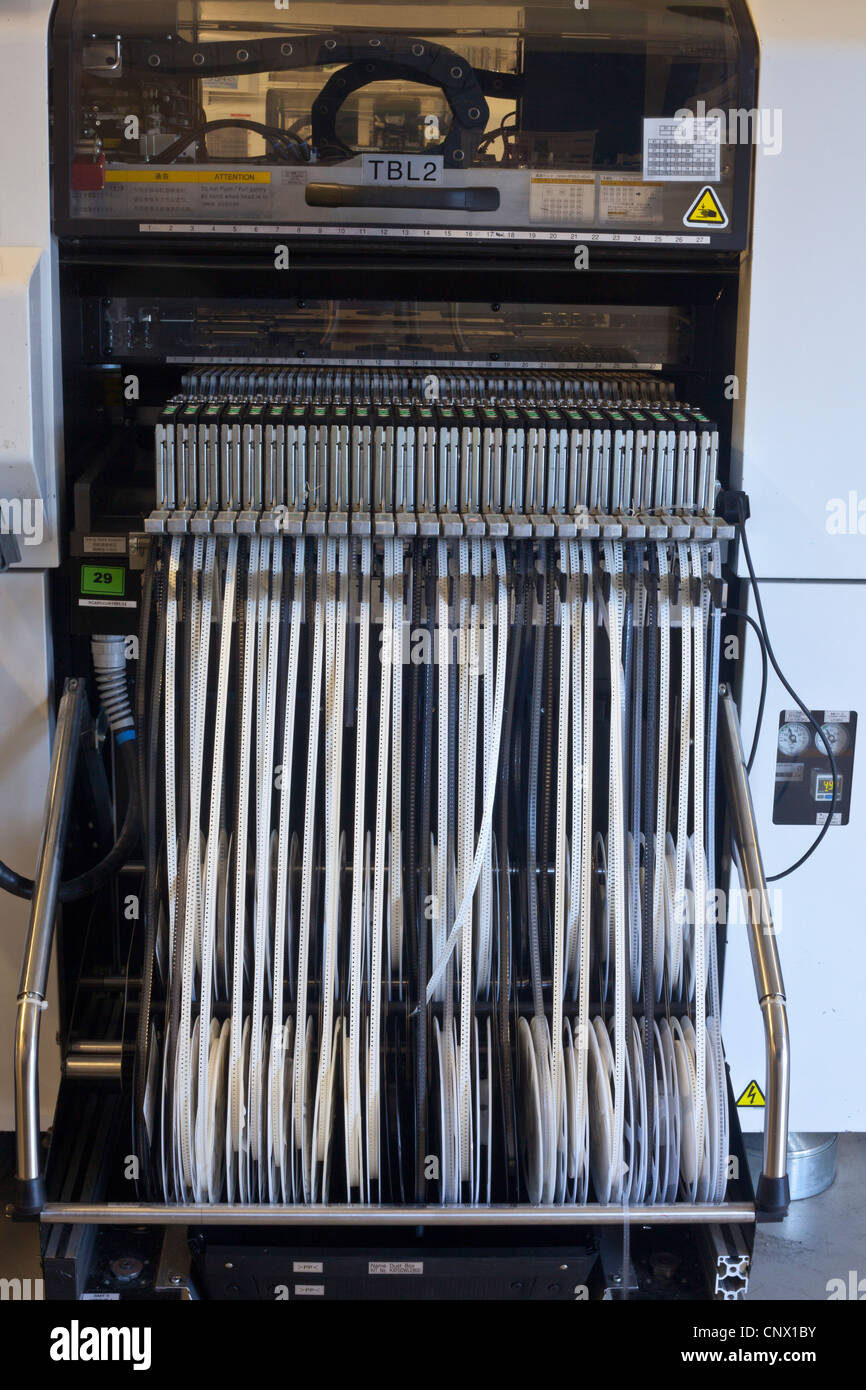 SMT SMD components loaded on feeders and placement machine carts ready ...