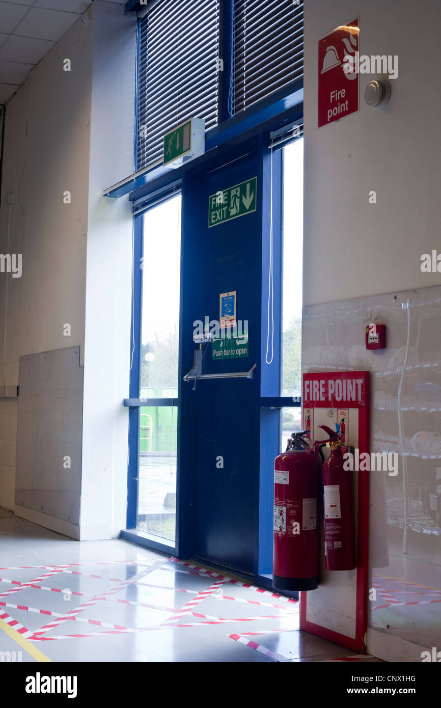 Fire point with extinguisher and fire alarms and exits Stock Photo - Alamy