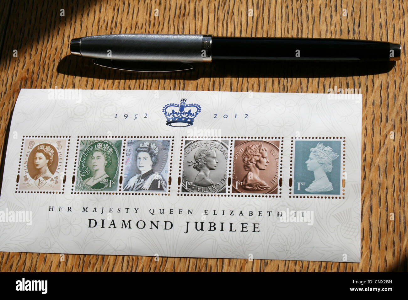 Diamond Jubilee stamps, pen and desk Stock Photo - Alamy