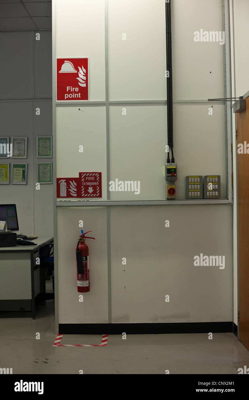 Fire point with extinguisher and fire alarms and exits Stock Photo - Alamy