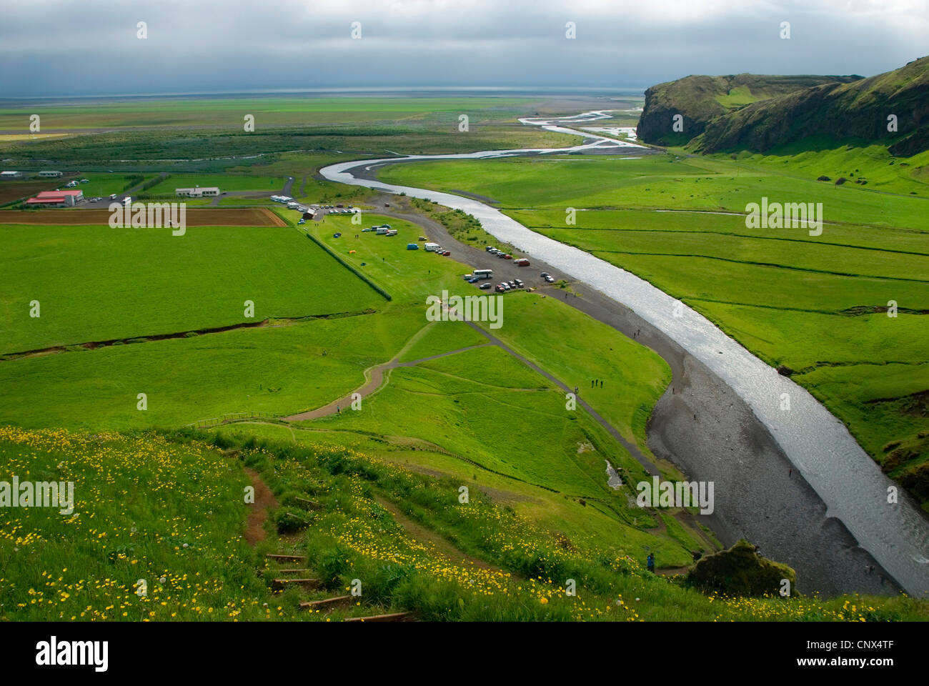 panoramic view from a hill on a vast plain with river Skoga winding ...
