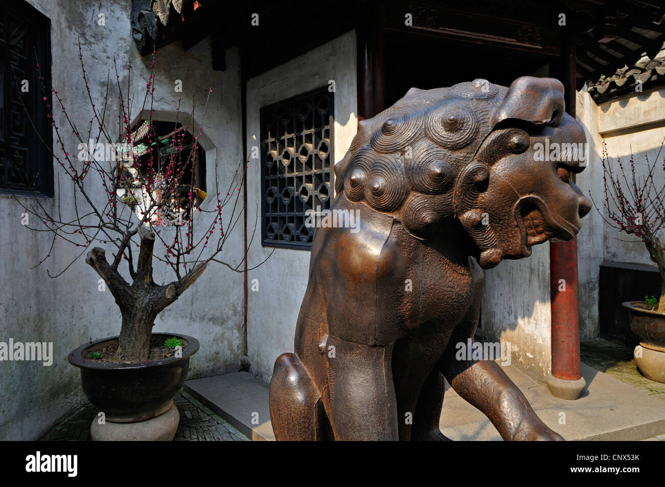Cast bronze statue of a temple guardian or lion-dog, YuYuan Gardens ...
