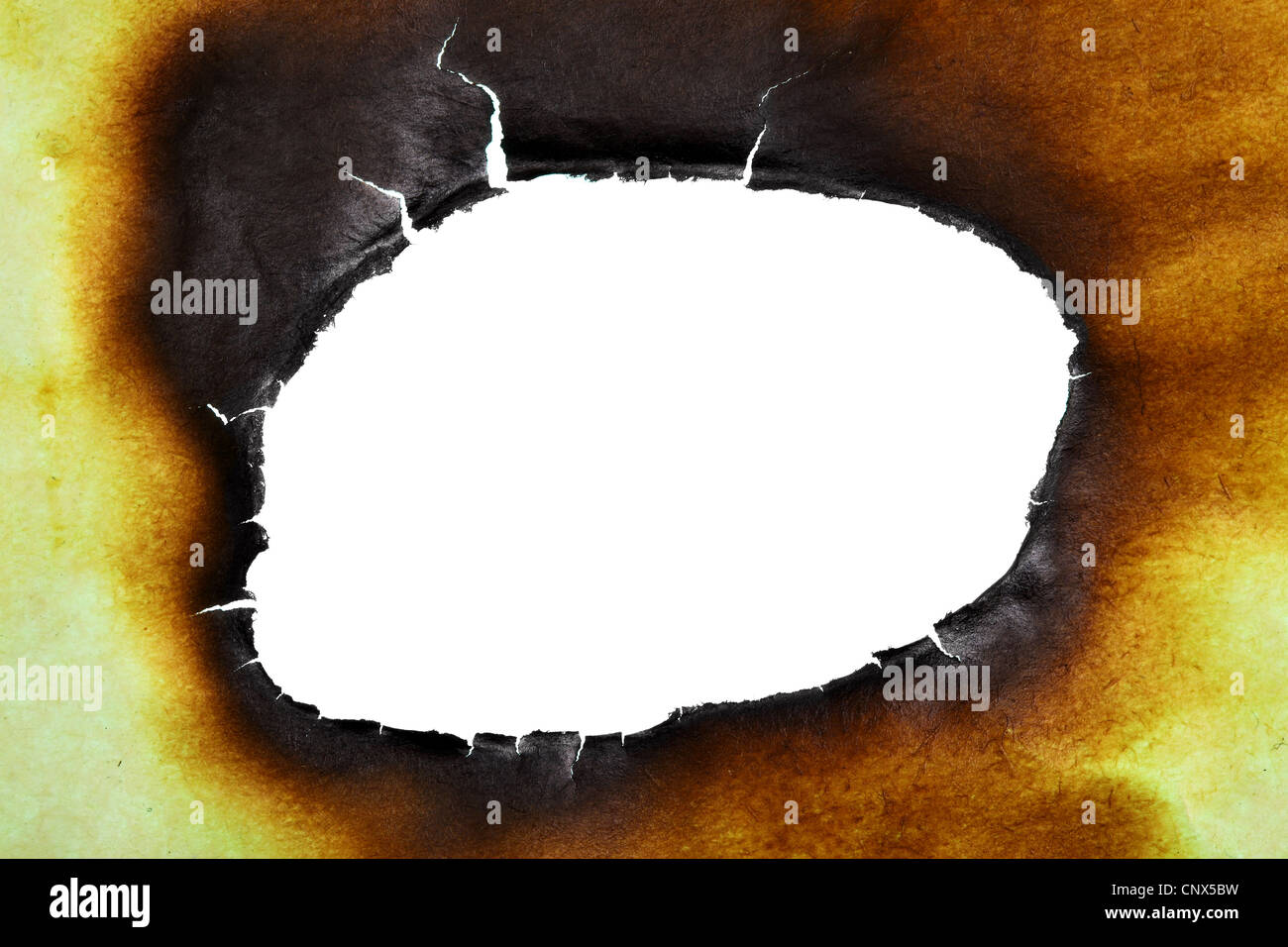 Close-up of hole burnt through old yellow paper Stock Photo - Alamy