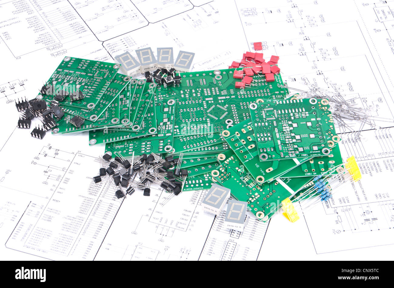 Circuit boards and electronic components with schematics in background ...