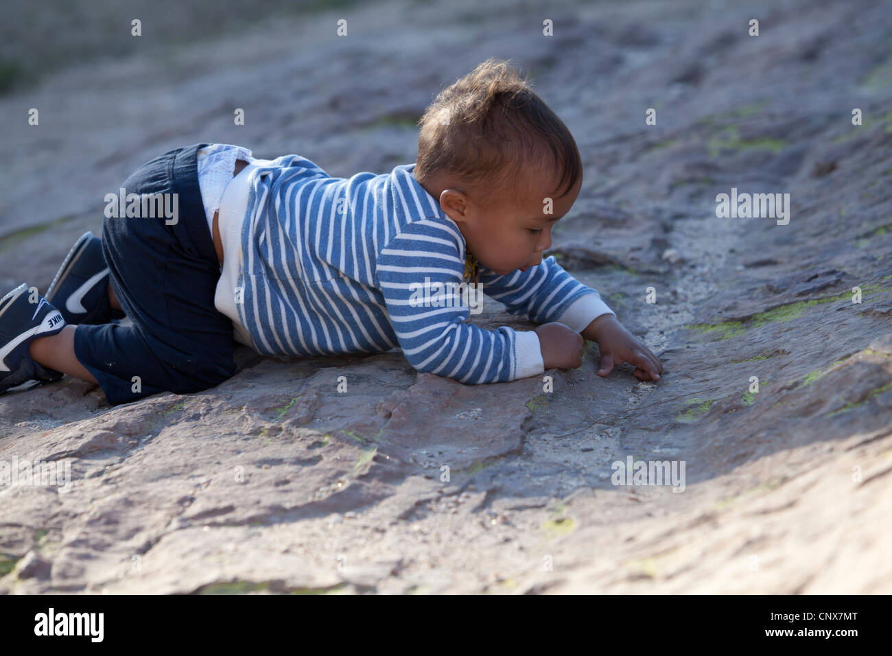 A child discovering rocks in the canyon Stock Photo - Alamy