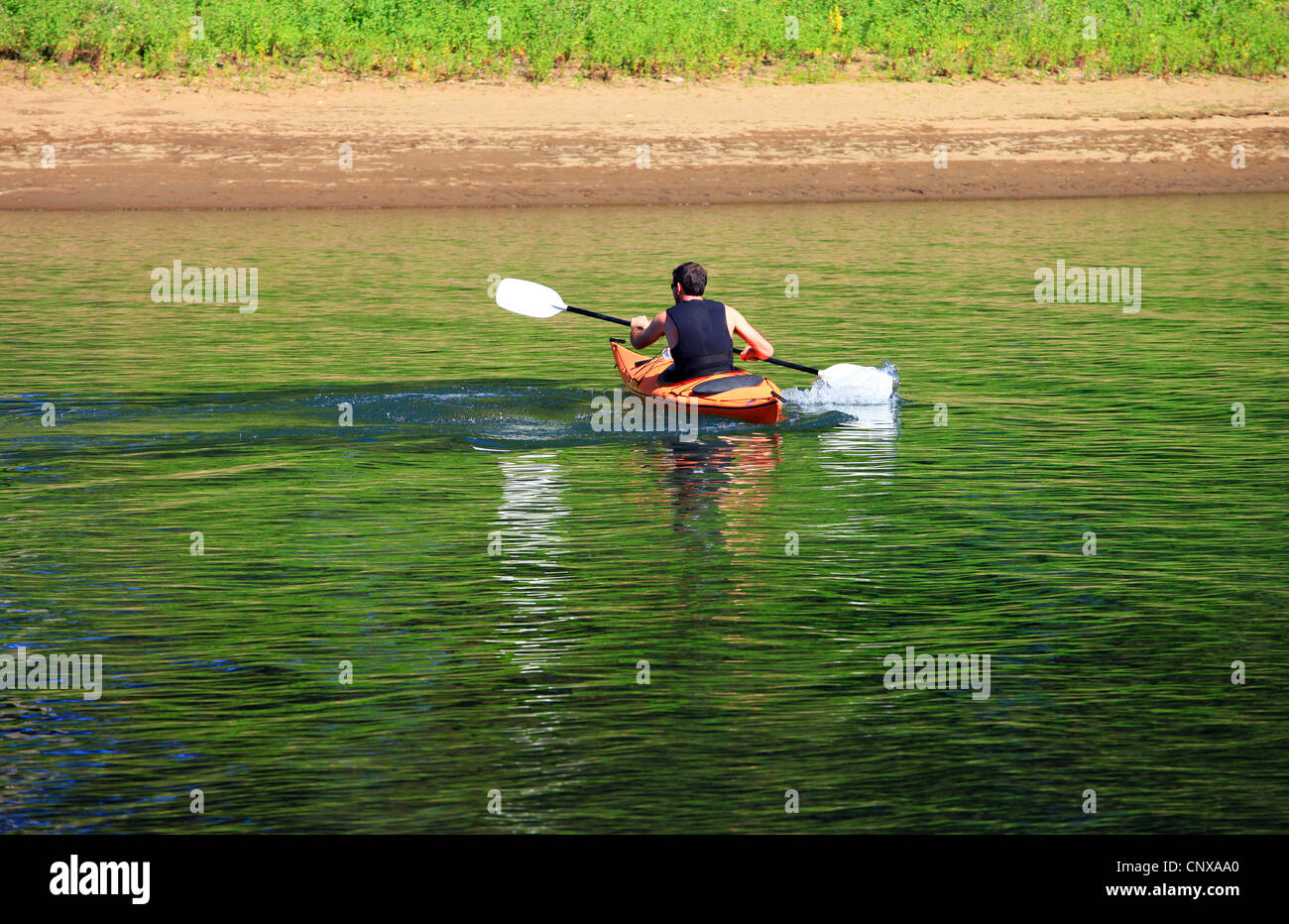 Making a turn with a kayak on a river Stock Photo - Alamy