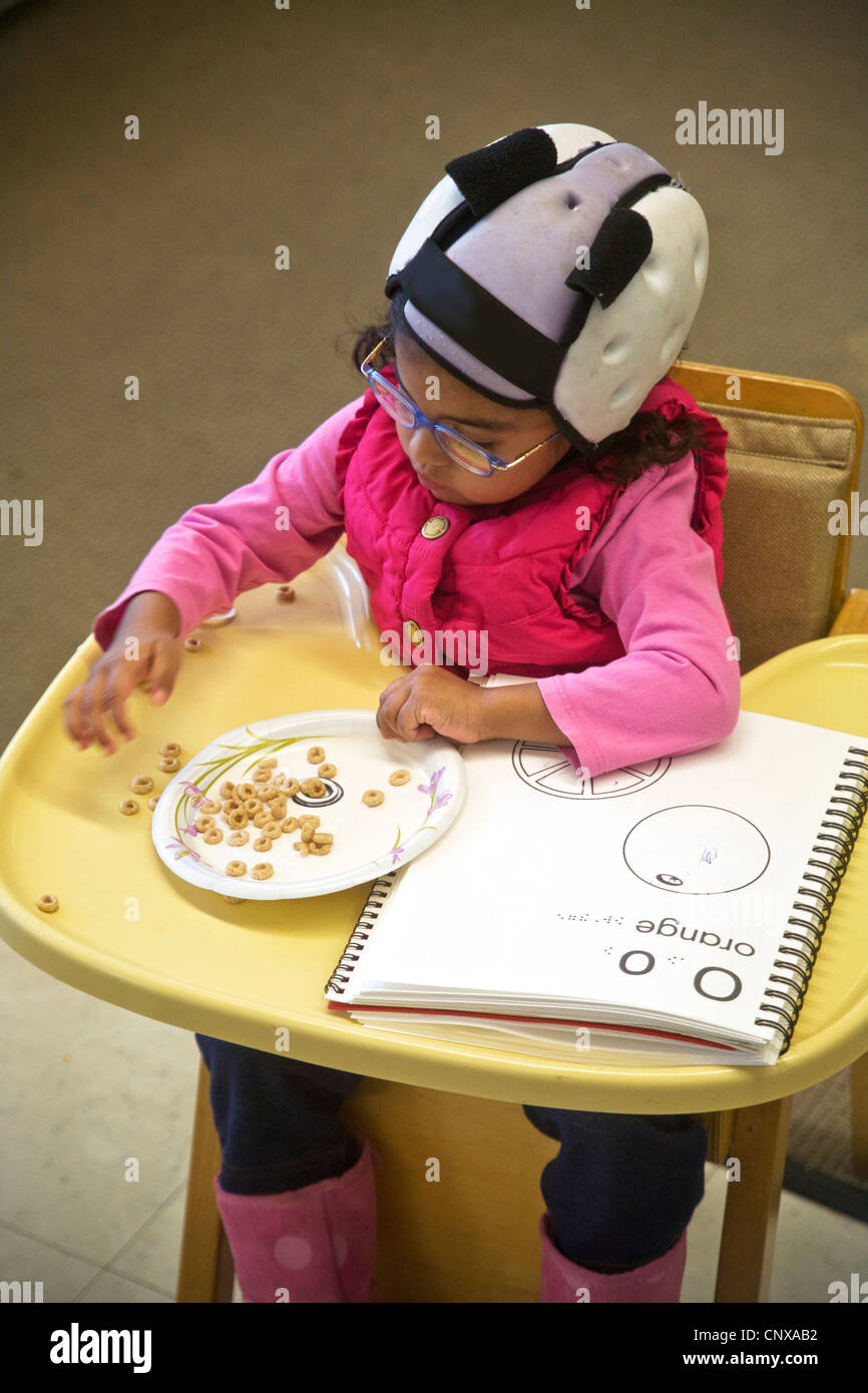 Using Cheerios, a visually impaired child learns the letter "O" by ...
