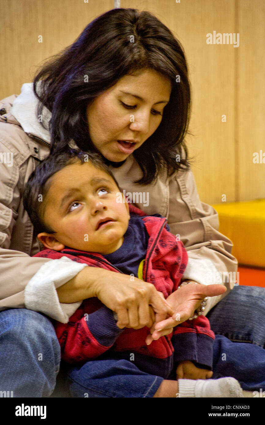 A Hispanic teacher comforts a disoriented frightened vision-impaired ...