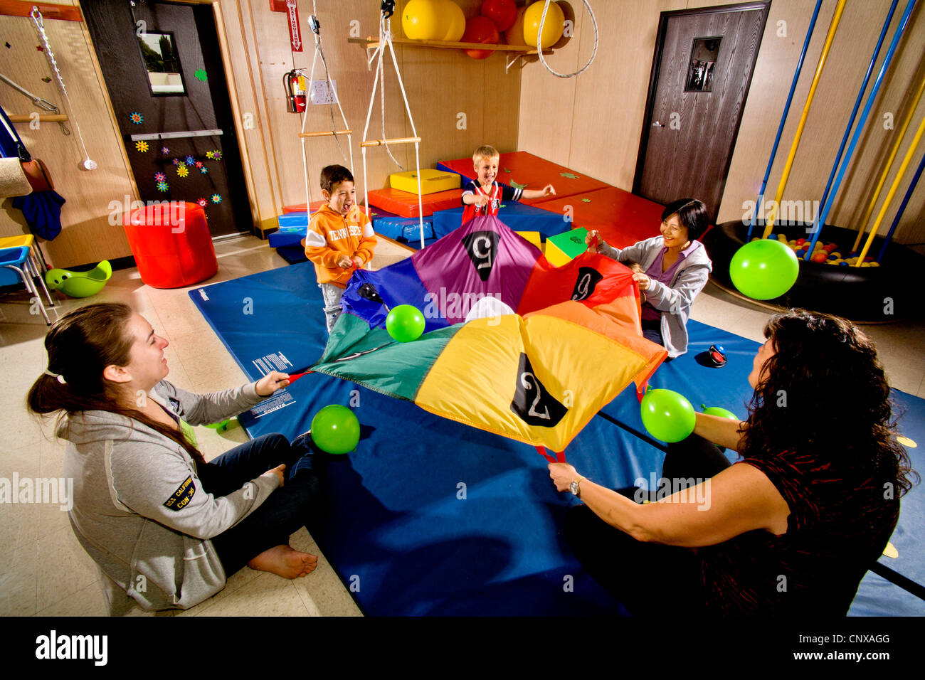 Teachers and visually-impaired students wave a parachute to promote ...