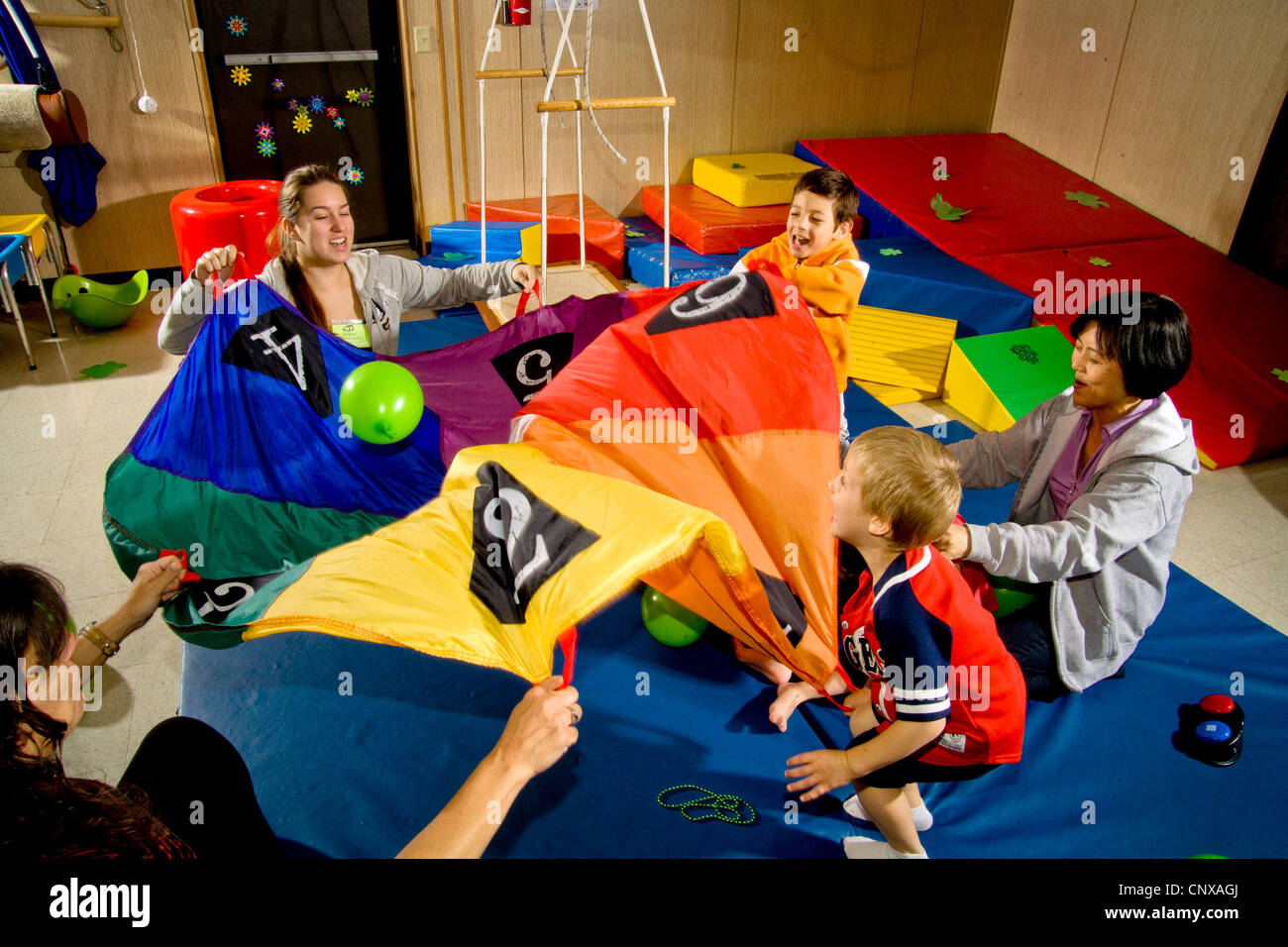 Teachers and visually-impaired students wave a parachute to promote ...