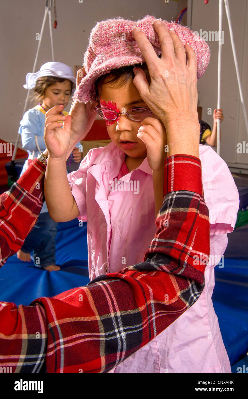 Partially blind girls don costumes for dress-up during an occupational ...