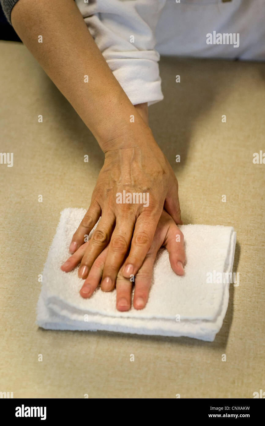 A teacher's hand guides the hand of a blind teen student learning to ...